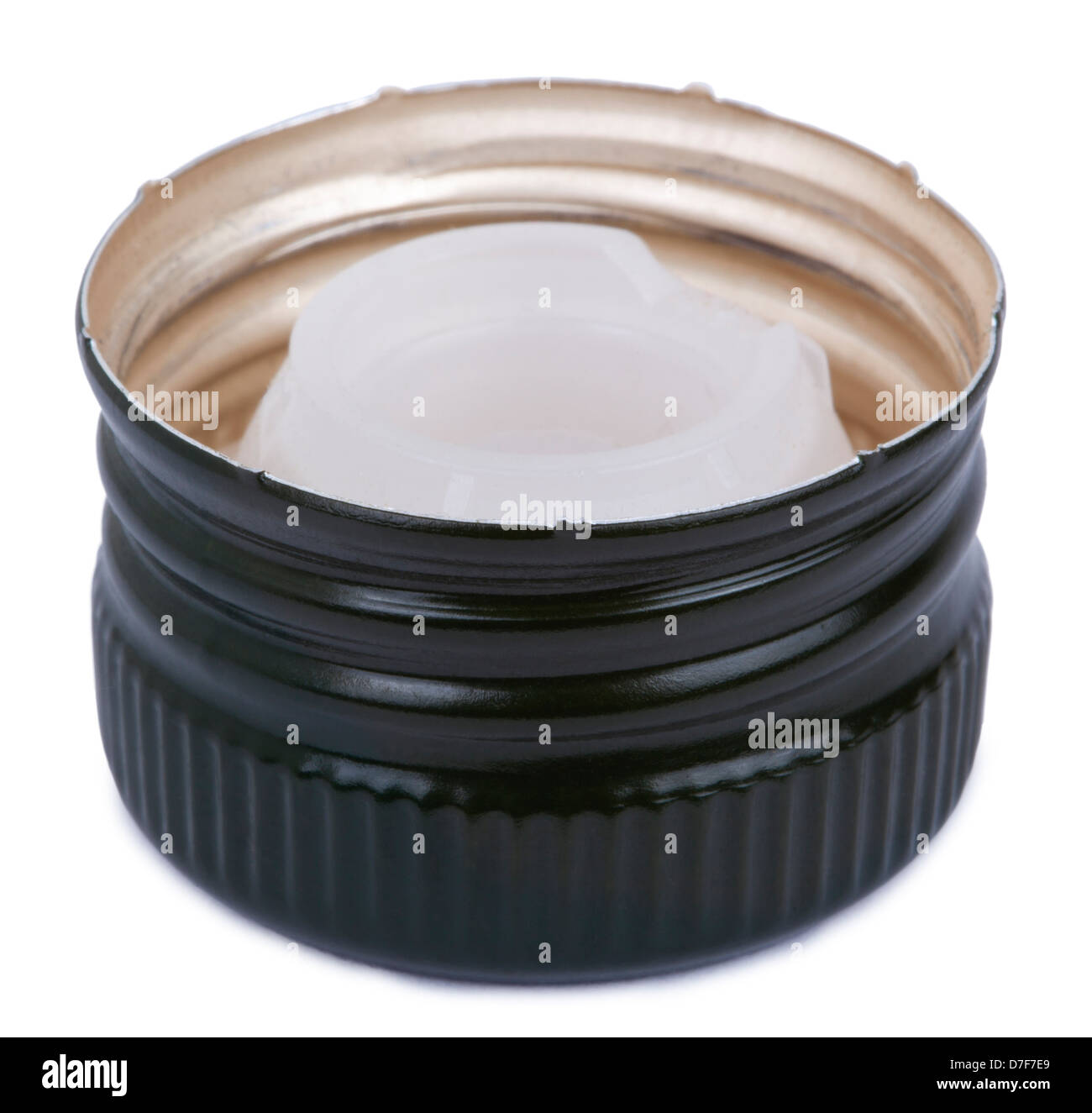 The inner side of a green metal bottle cap, seen from a slightly high ...