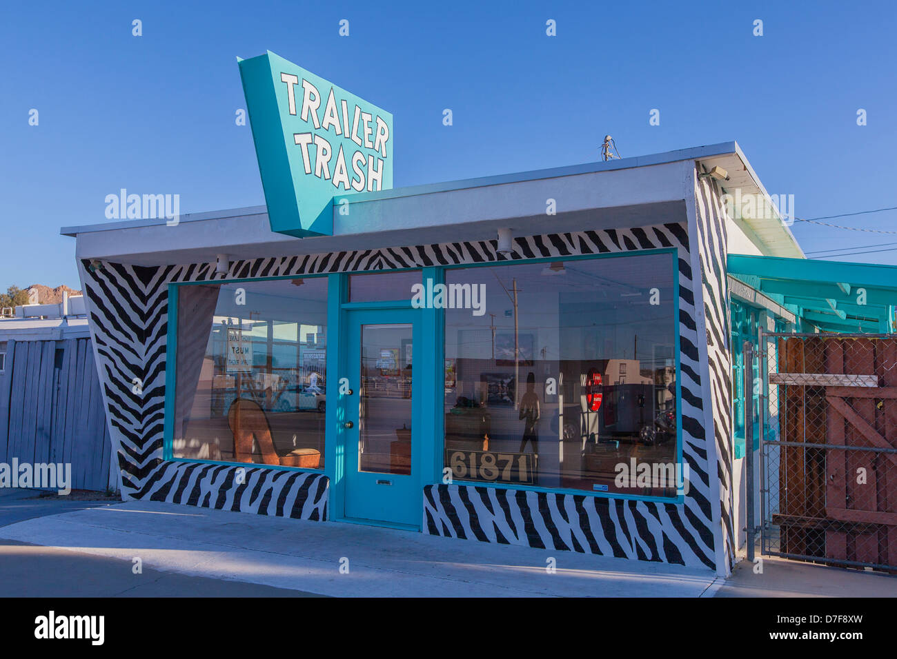 A black and white zebra striped and turquoise colored storefront with a ...