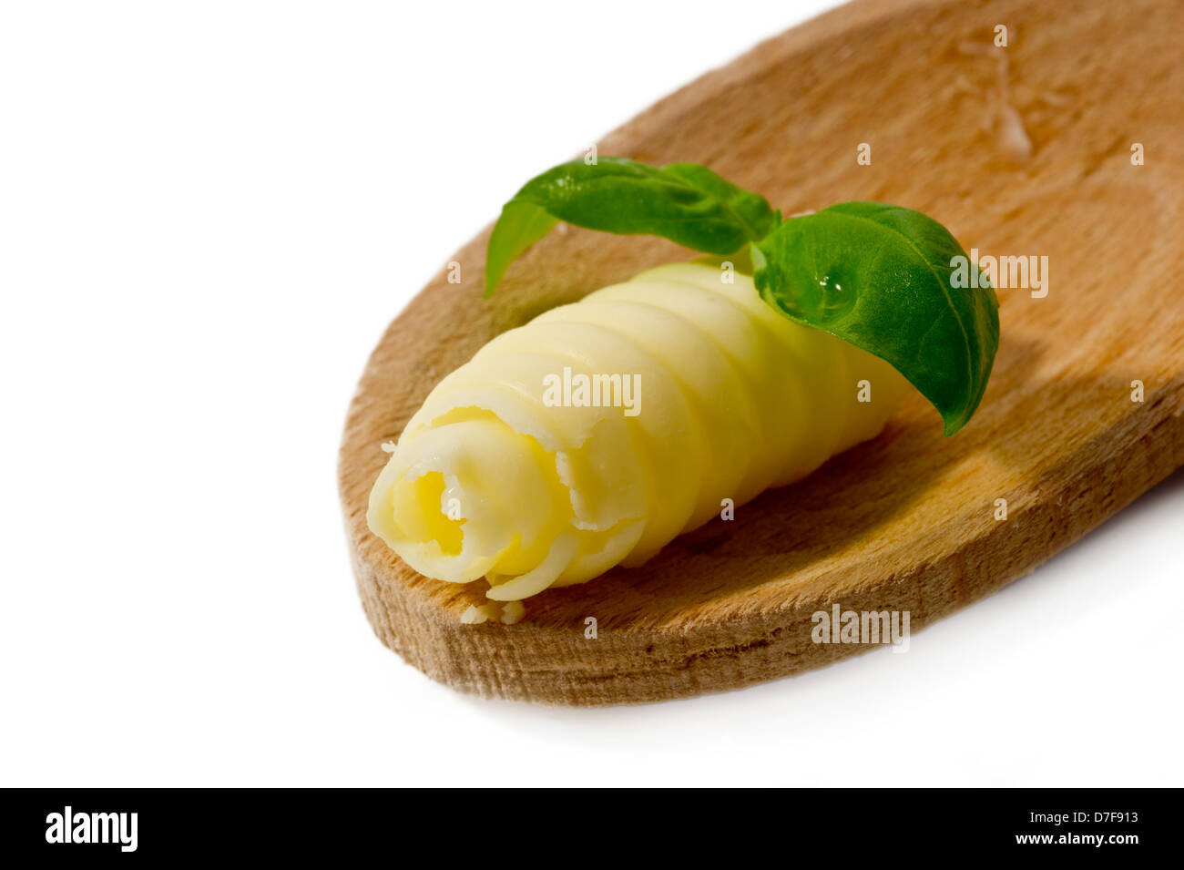 Butter curl on a wooden spoon on white background Stock Photo - Alamy