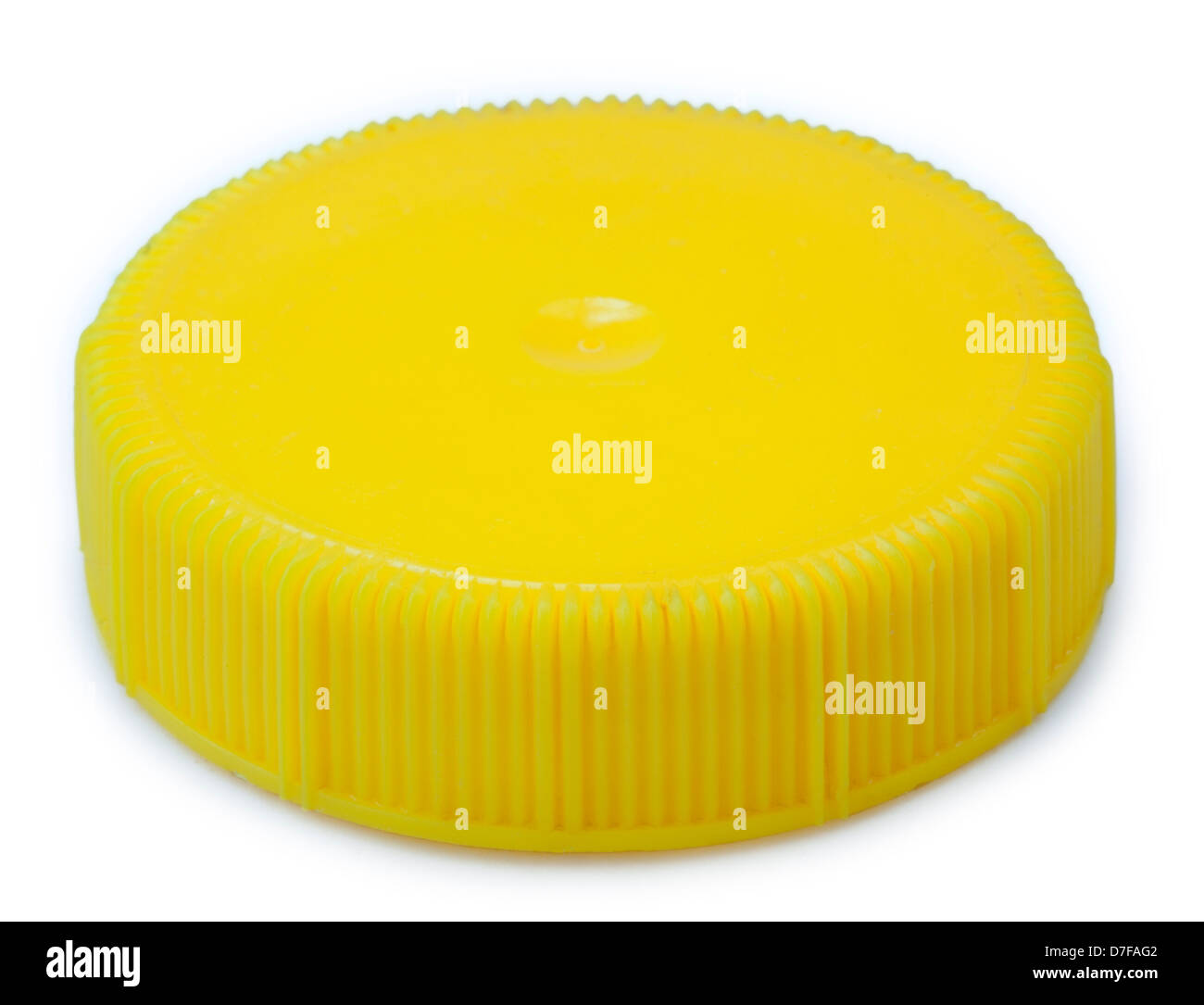 Single yellow plastic bottle cap isolated on white background. Top side ...