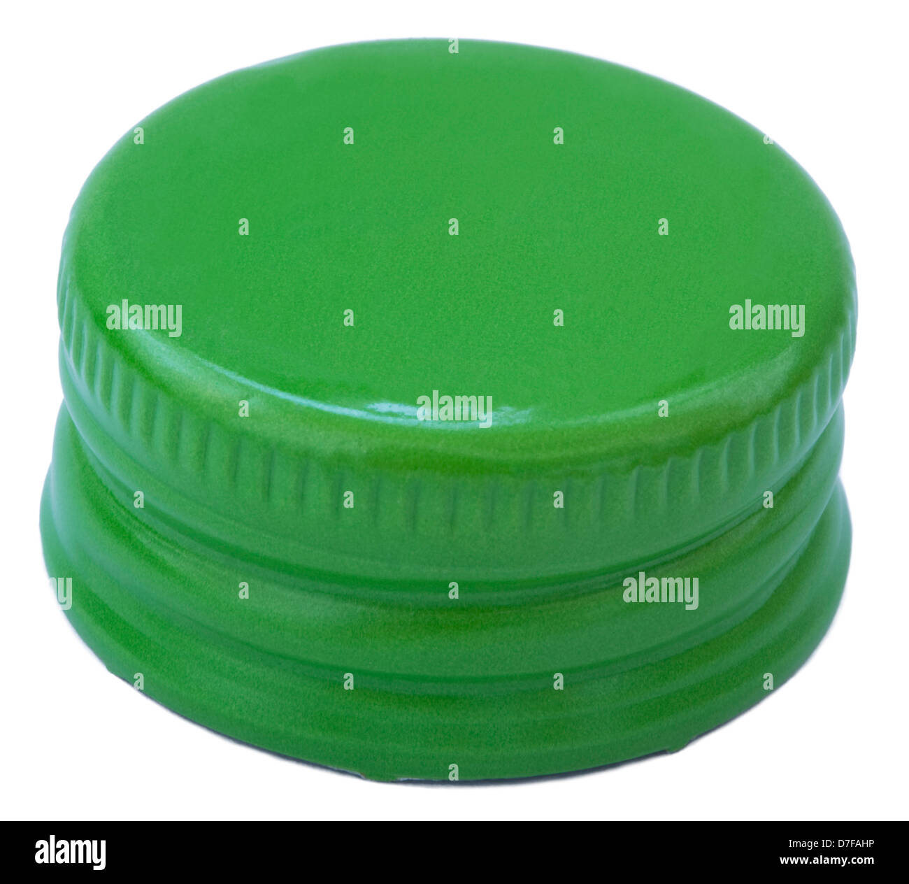 The top side of a green metal bottle cap, seen from a slightly high ...