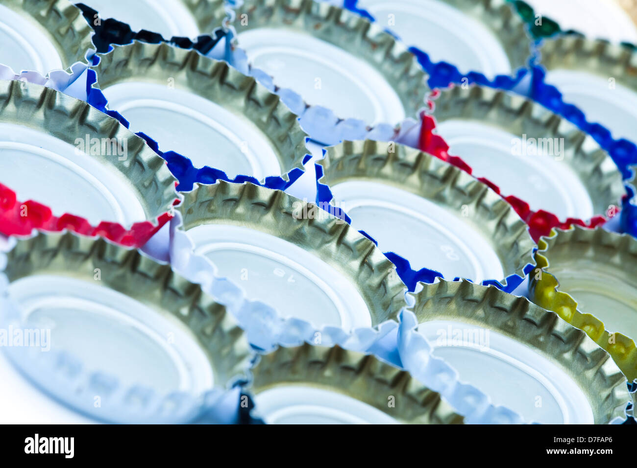 Five rows of metal bottle caps aligned upside down and diagonally to ...