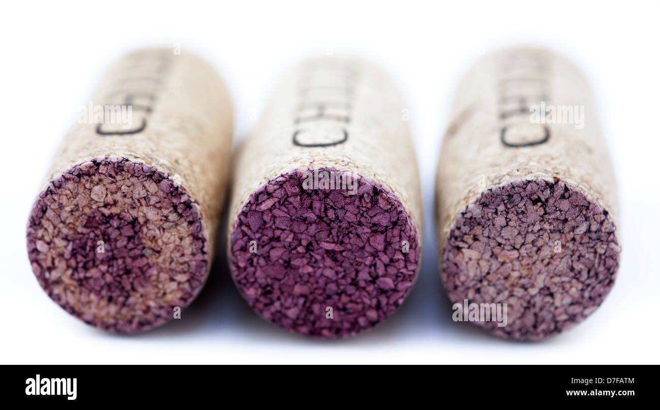Three corks aligned in a row isolated on white background. Very shallow ...