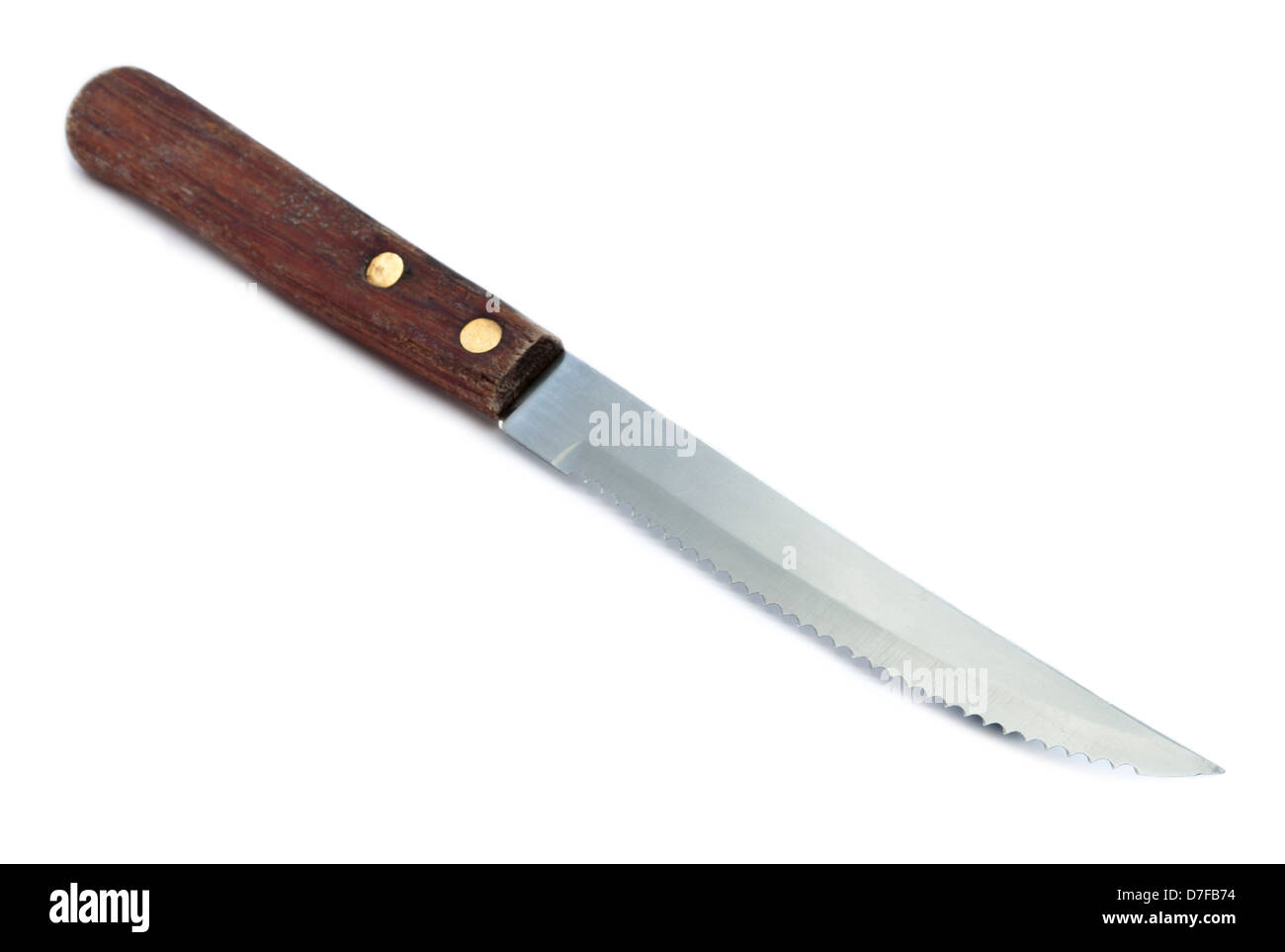 A used jagged meat cutting knife with a wooden handle isolated on white ...