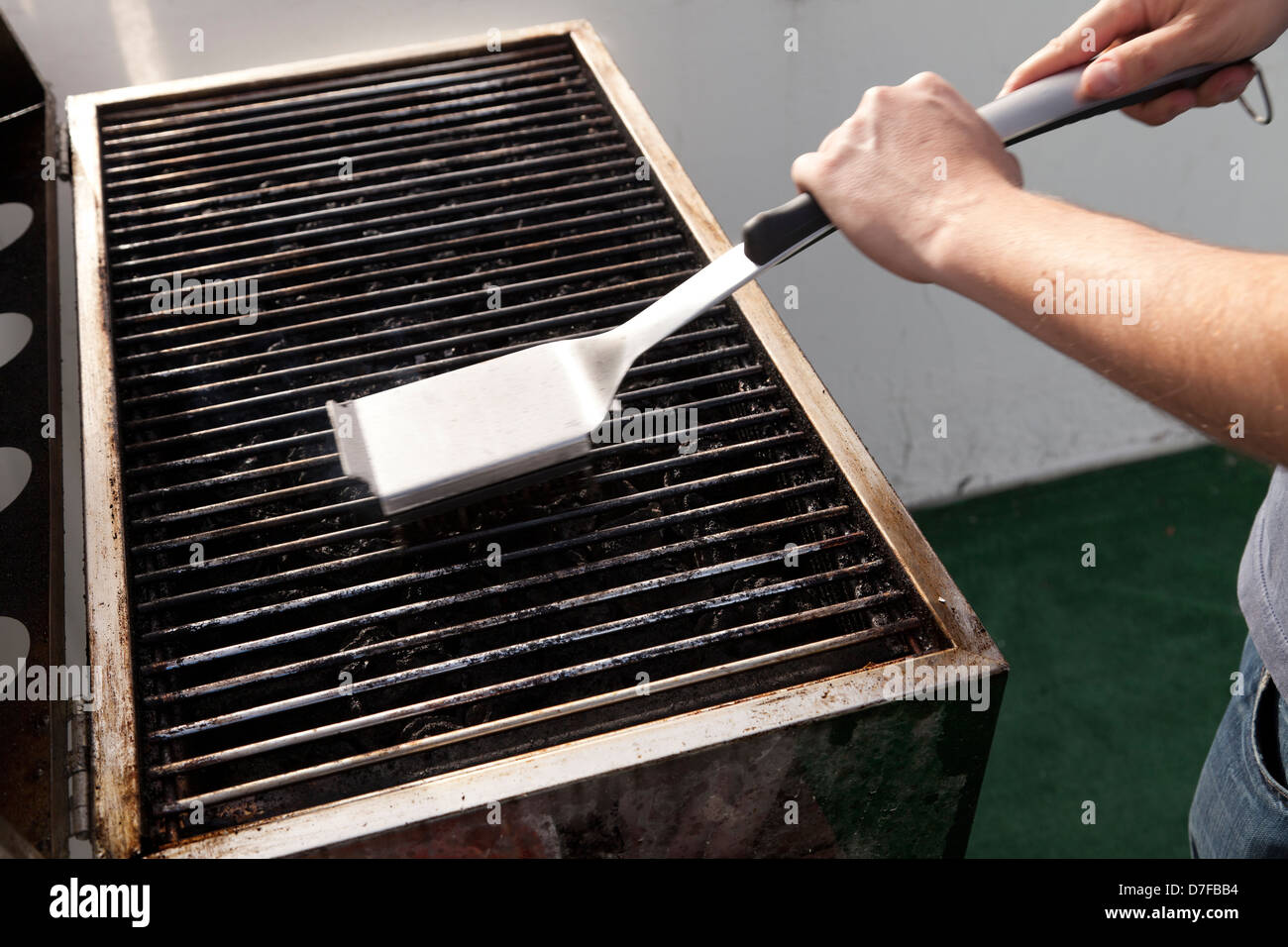 Getting the grill ready for some cooking - scraping old fat with the ...