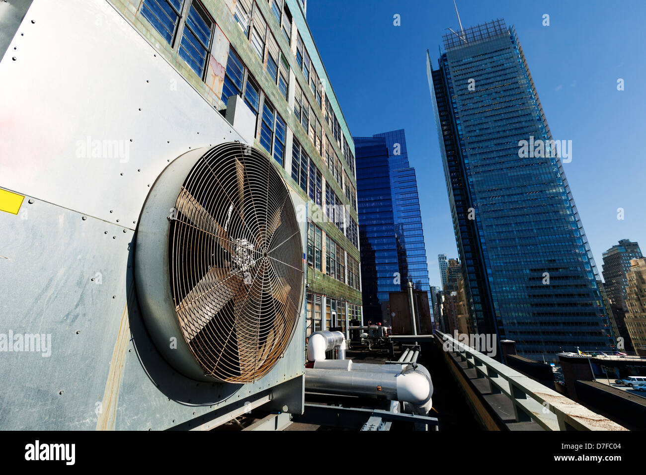 Wide angle view at an outdoor HVAC air conditioner unit located on a ...