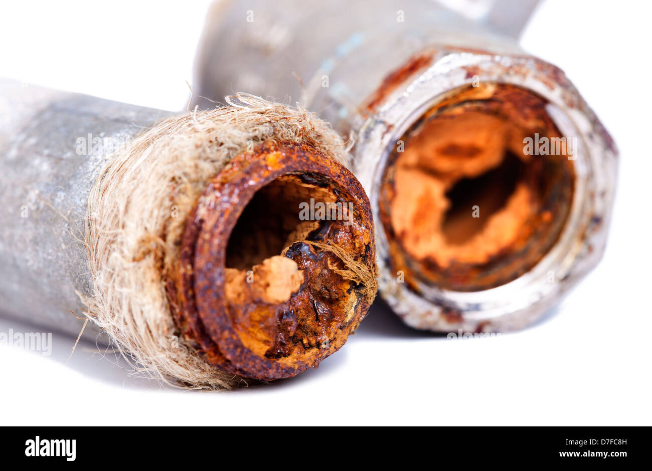 Two broken plumbing pipe almost completely blocked with vibrant orange ...