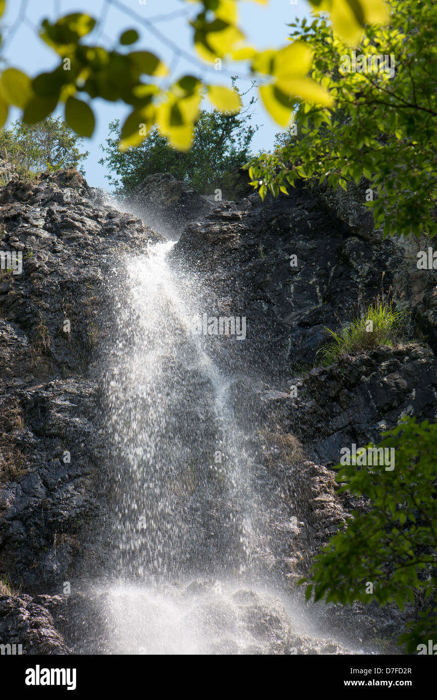 waterfall falling down rocks in the forest Stock Photo - Alamy