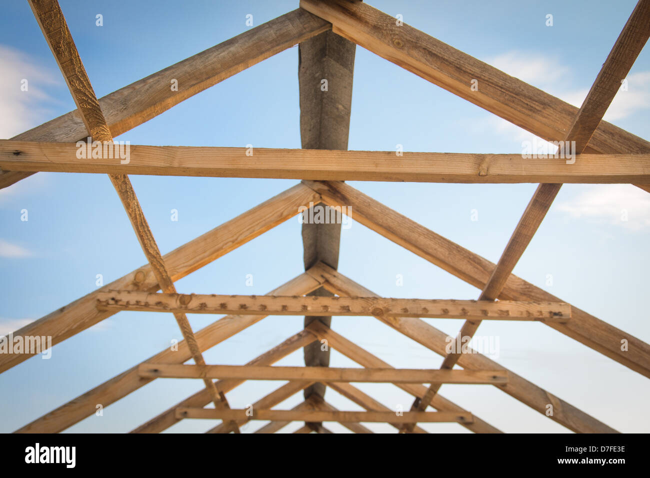 Construction of roof, wooden pine symmetric skeleton and blue sky Stock ...