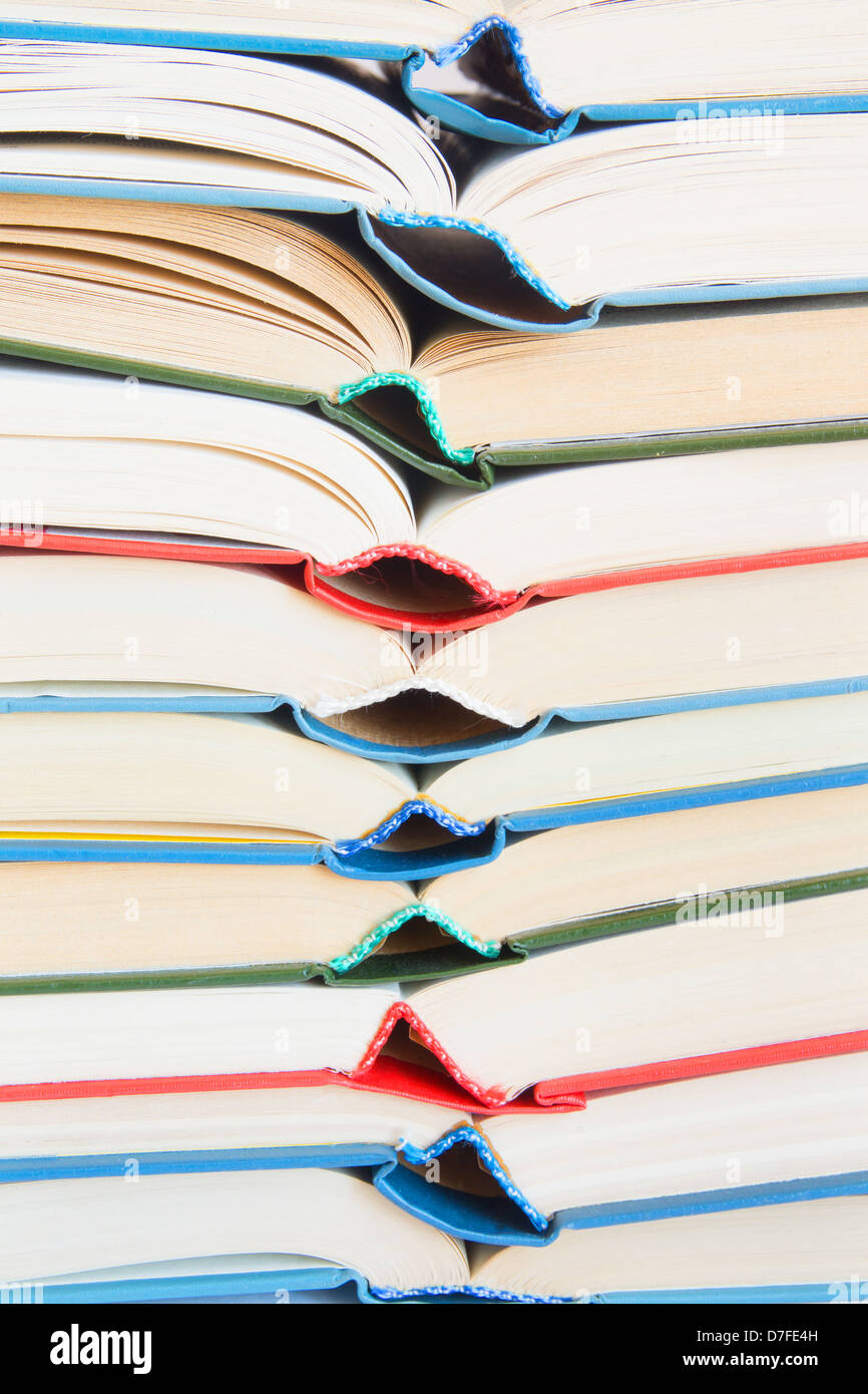 Stack of open multicolored books close up. Vertical background Stock ...