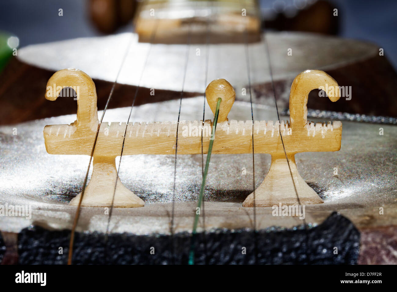 Macro close-up on bridge Persian Tar musical string instrument. Tar is ...