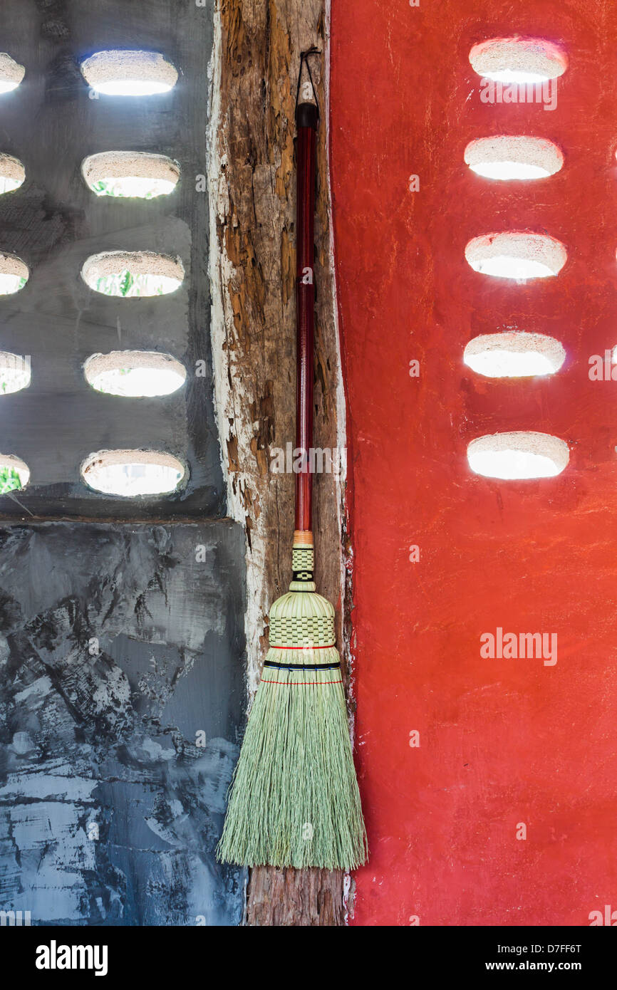 Broom hanging on the wall ready for cleaning work Stock Photo - Alamy
