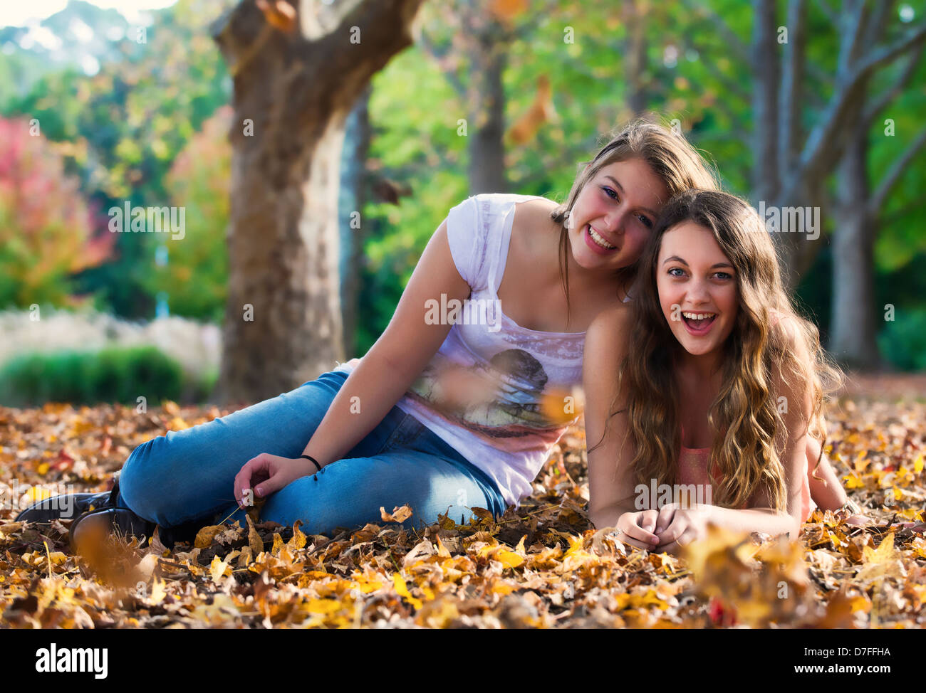 Two best friends share a laugh in a park Stock Photo - Alamy