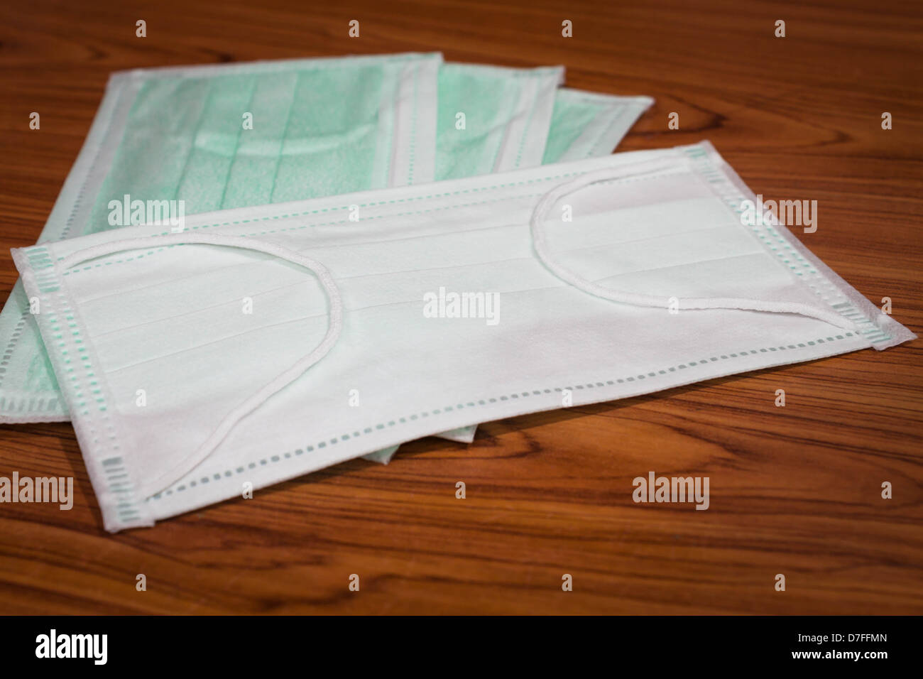 New medical green mask on wood background Stock Photo - Alamy