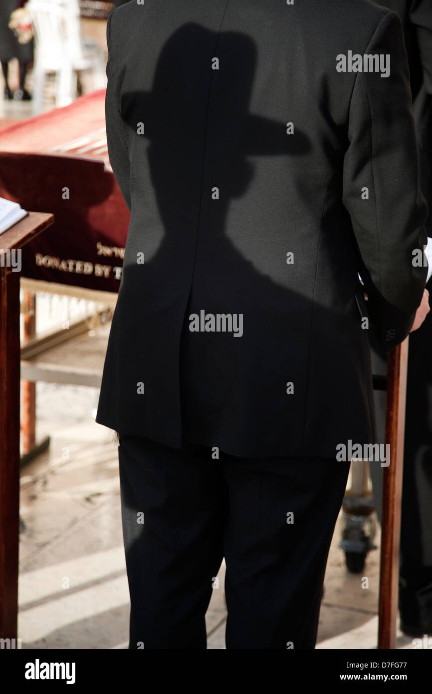 A shadow an orthodox Jewish man casted on back side suit orthodox ...