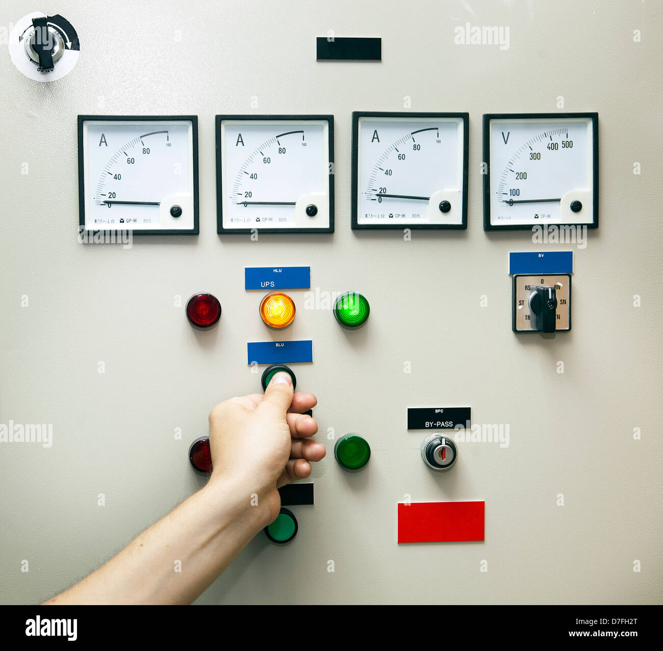 Electricity distribution controller & testing unit. An adult man's hand ...