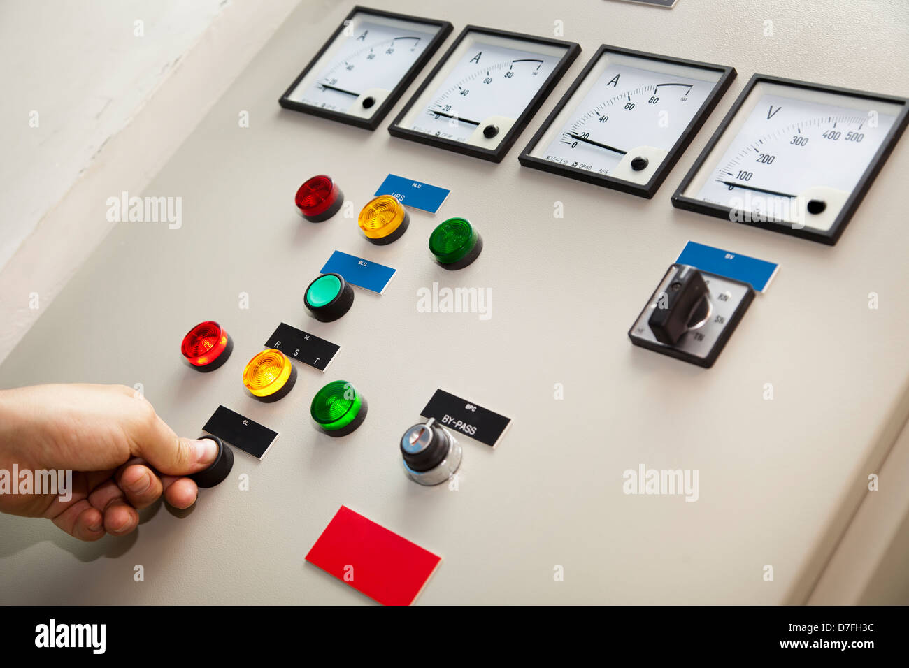 Electricity distribution controller & testing unit. An adult man's hand ...