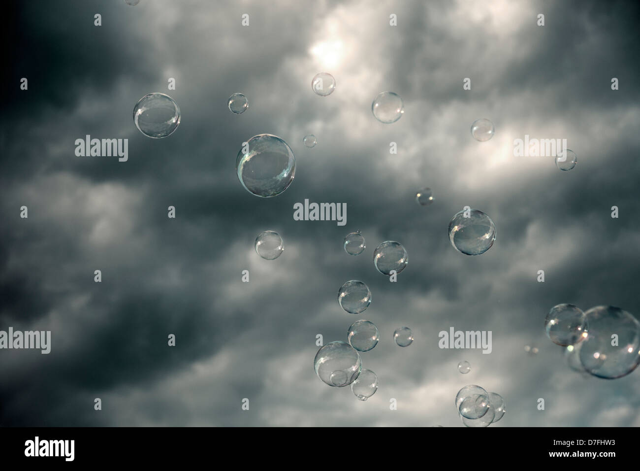 Soap sud bubbles floating in the air on the background of dramatic sky ...