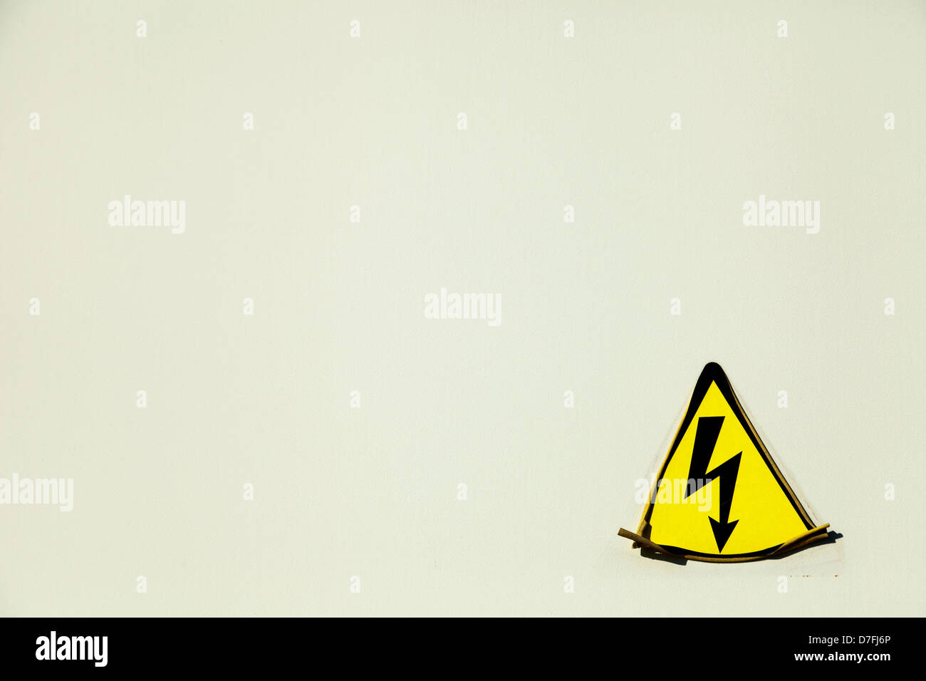 Old electric hazard sticker starting to peel off of the bright beige ...