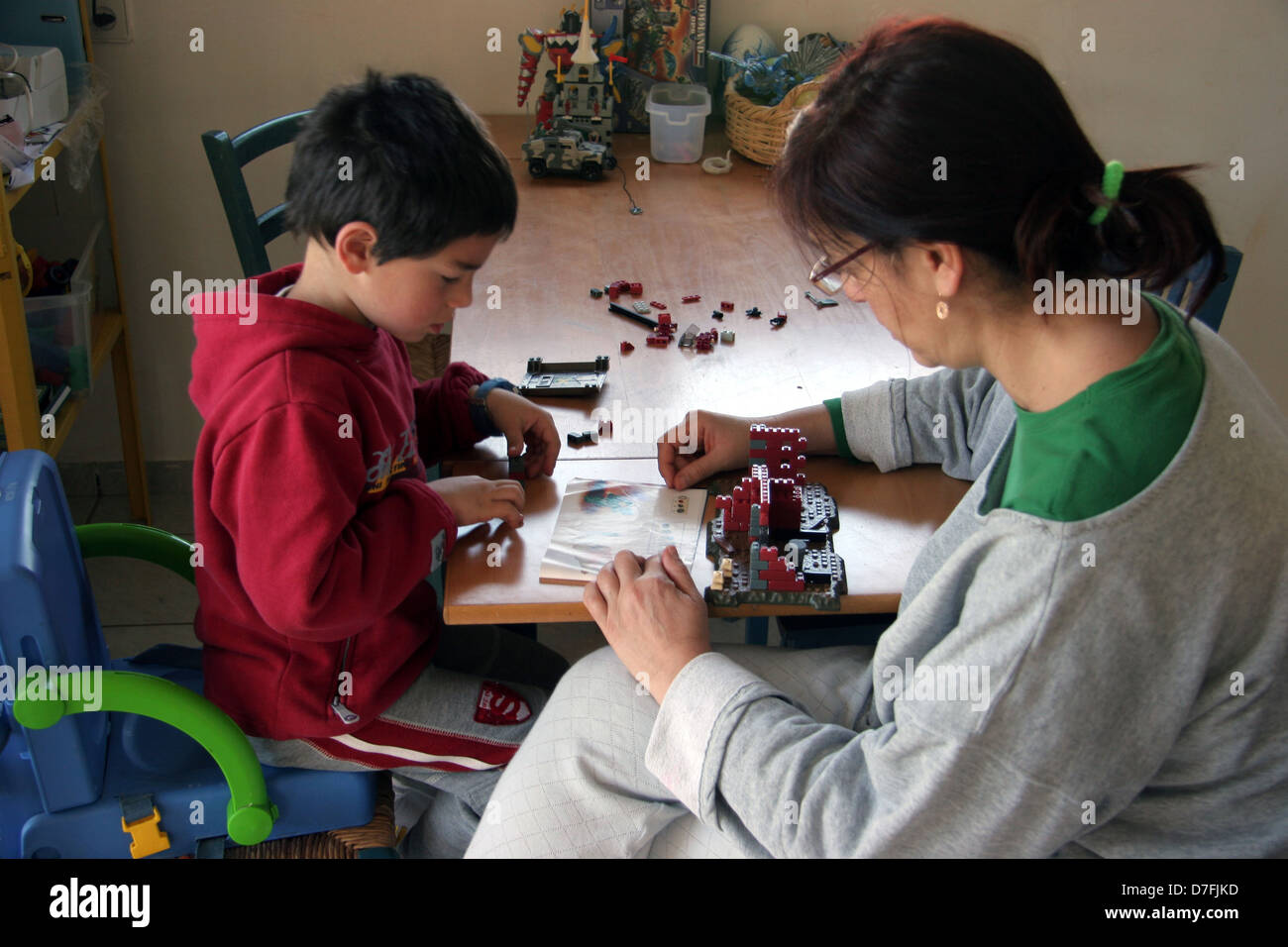 mother helping her son assembling lego pieces (2006 Stock Photo - Alamy