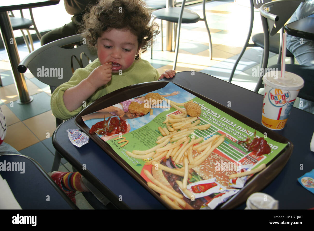 young child eating fast food at McDonald's, regba, Western Galilee ...