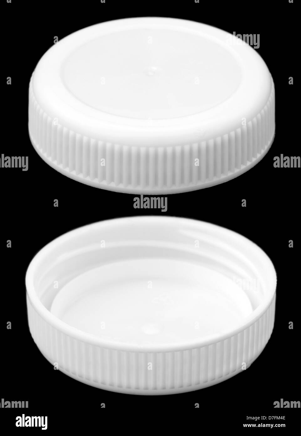 Two sides of a white plastic bottle cap seen from a slightly high angle ...