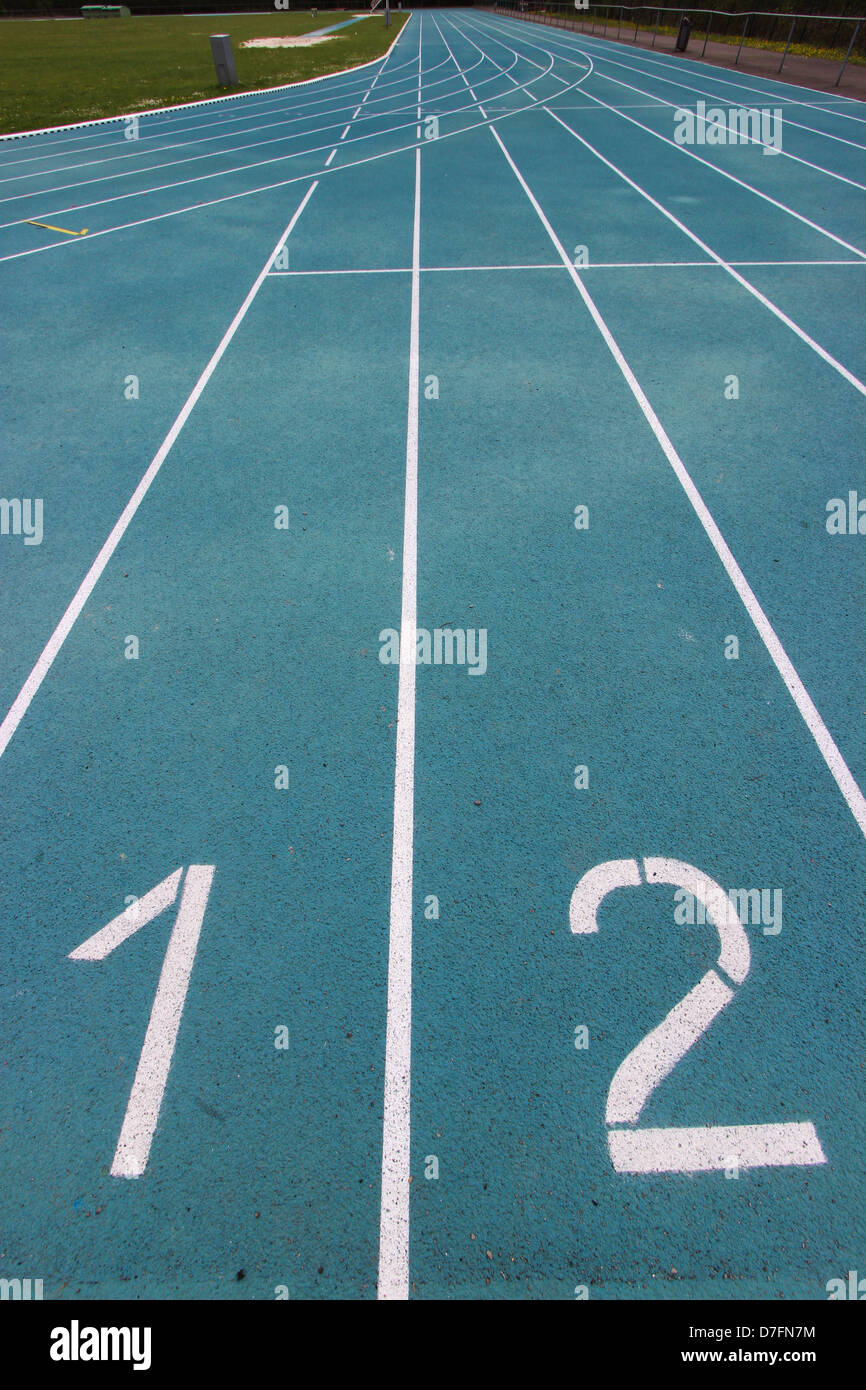 running racetrack with white lines on blue ground Stock Photo - Alamy