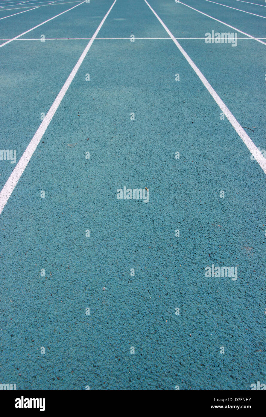 running racetrack with white lines on blue ground Stock Photo - Alamy
