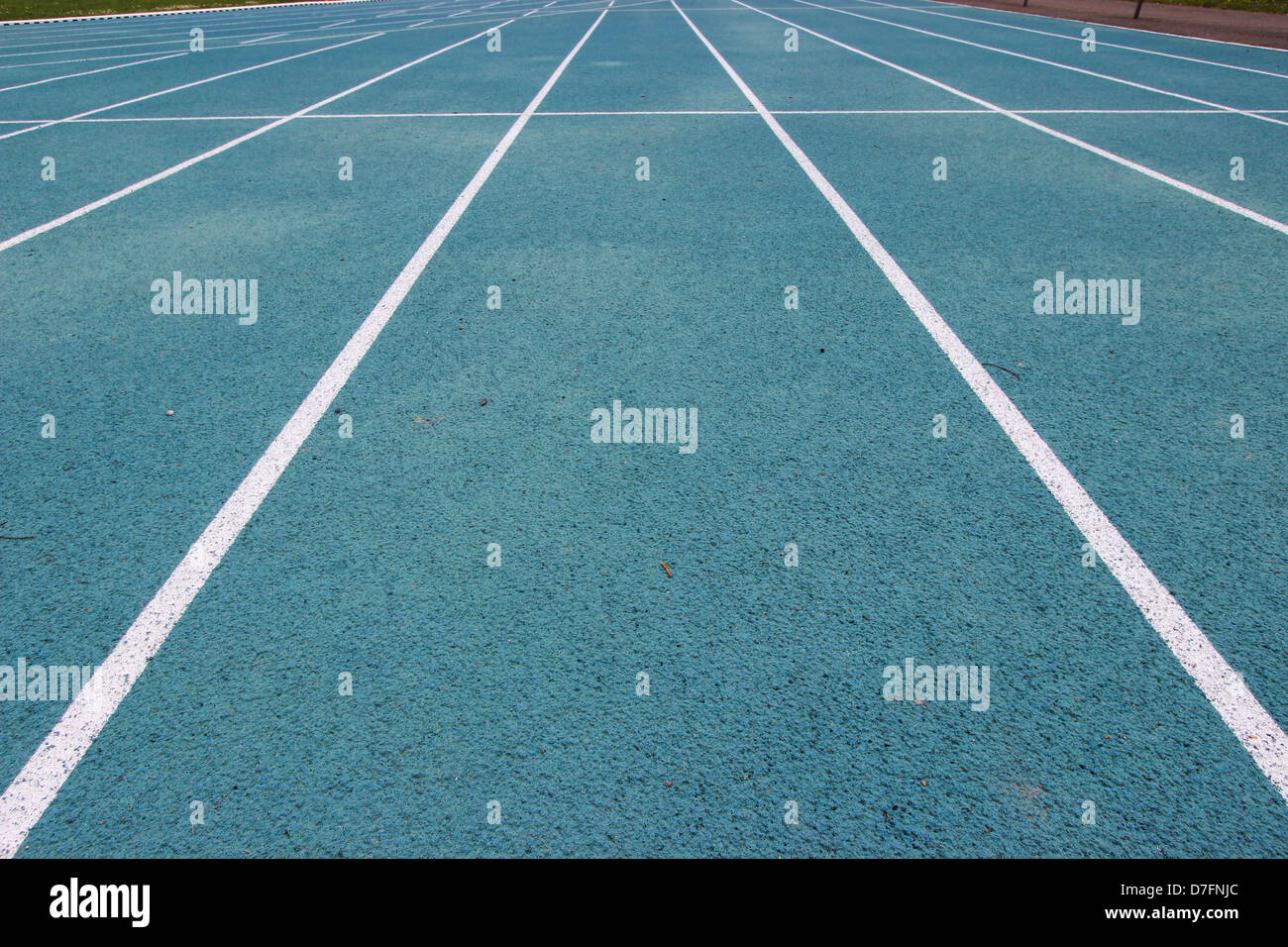 running racetrack with white lines on blue ground Stock Photo - Alamy