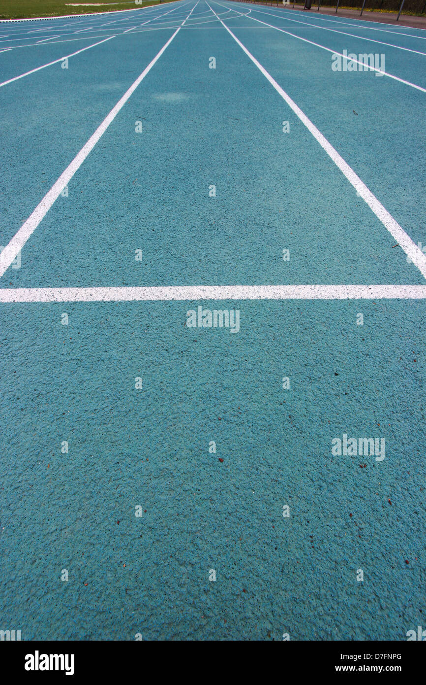 running racetrack with white lines on blue ground Stock Photo - Alamy