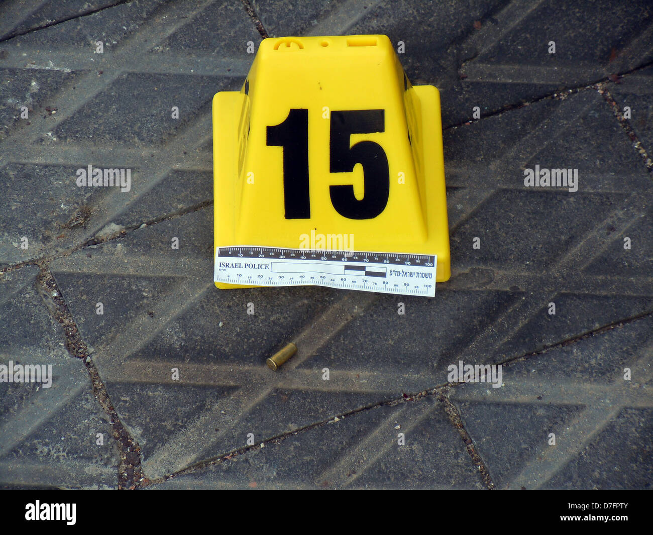 Police evidence marker next to a cartridge (Shell of a bullet) at a ...