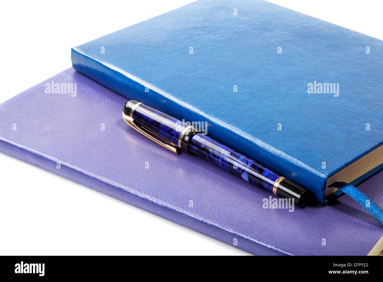 Dark blue writing-books and fountain pen isolated on a white background ...