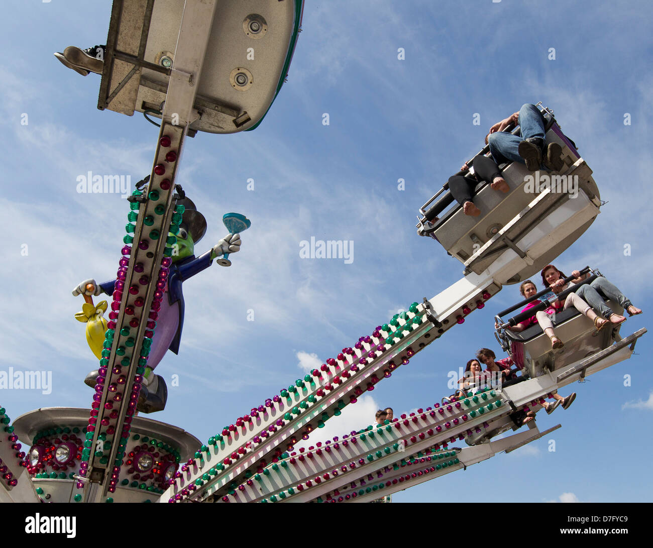 Older children enjoying a fairground ride at a May Fayre Stock Photo ...