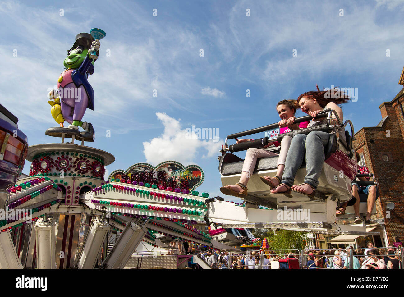 Older children enjoying a fairground ride at a May Fayre Stock Photo ...