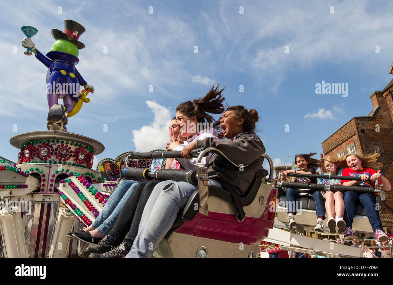 Older children enjoying a fairground ride at a May Fayre Stock Photo ...