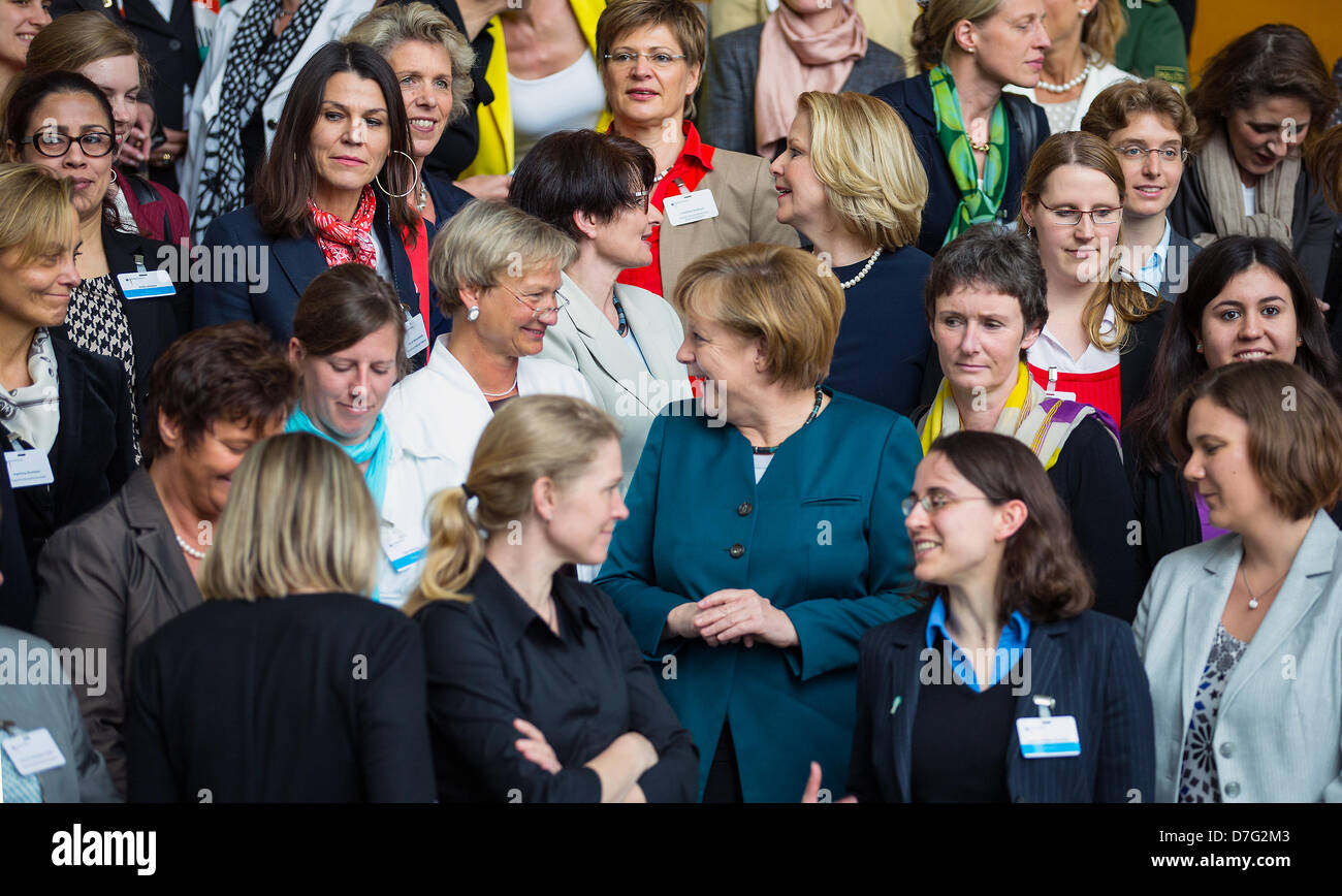 German chancellor Angela Merkel (C) poses for a group photo during a ...