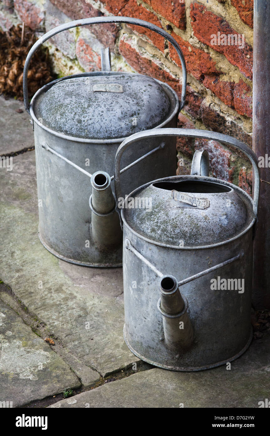 A pair of metal watering cans Stock Photo - Alamy