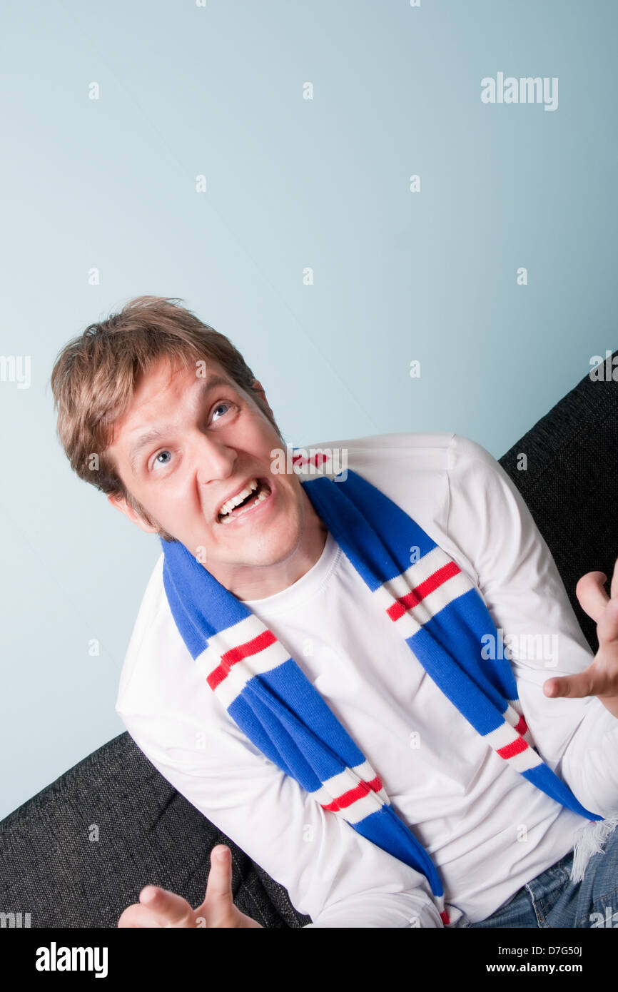 crazy young man supporting his football team Stock Photo - Alamy