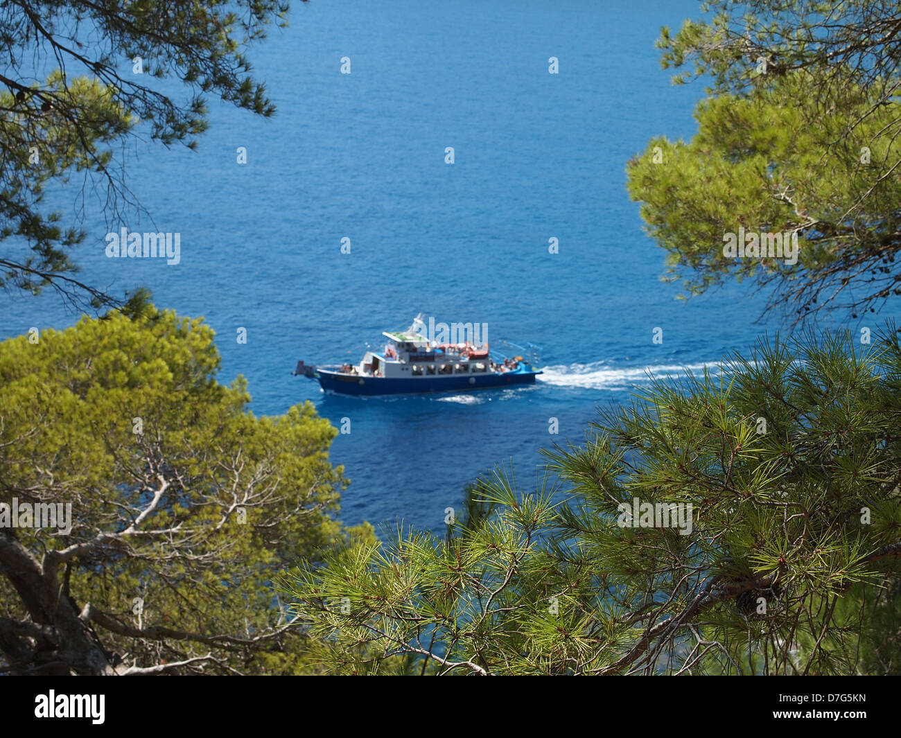 A view at a boat through pine branches Stock Photo - Alamy