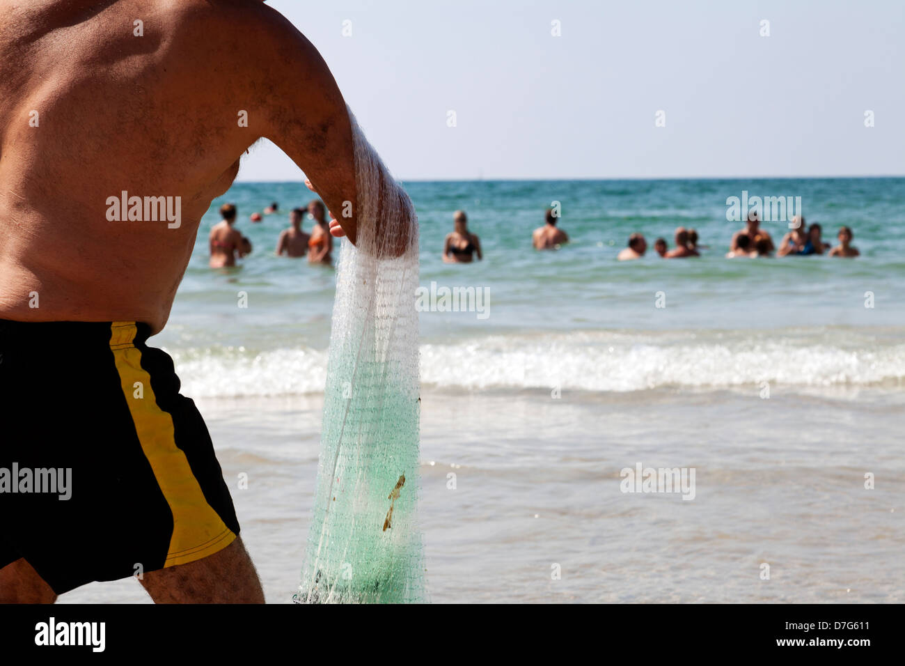 Tel-Aviv, Israel - August 18th, 2012: A mature man pulling a fishing ...