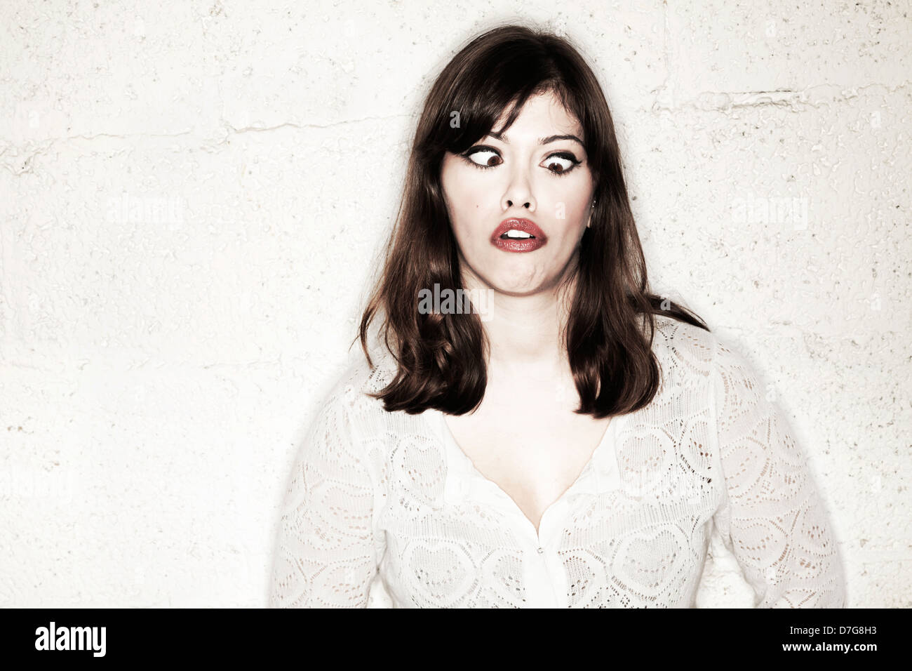 Portrait beautiful young woman very peculiar cross-eyed expression ...