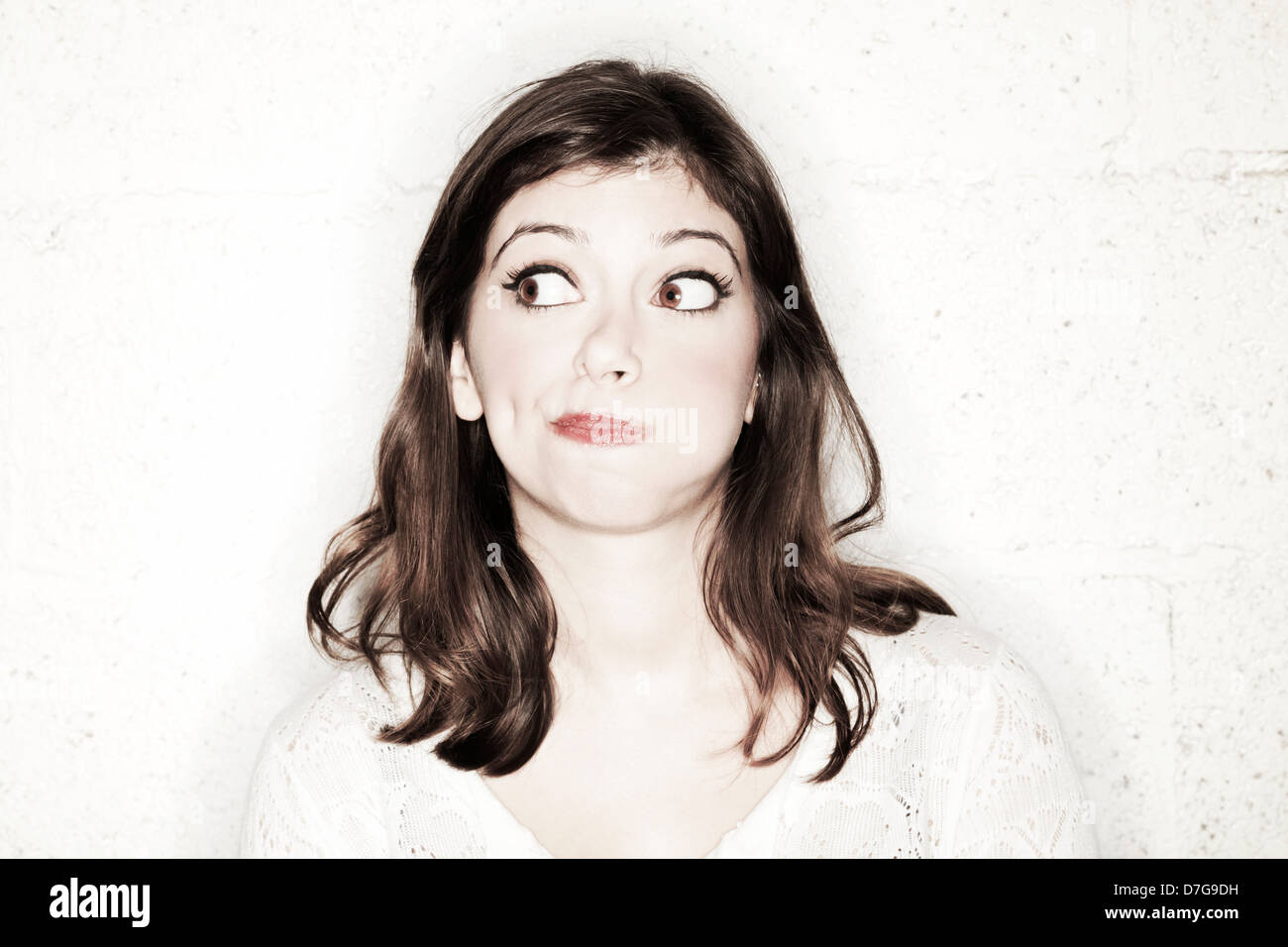 Portrait beautiful young woman her eyes wide open glancing sideways she ...