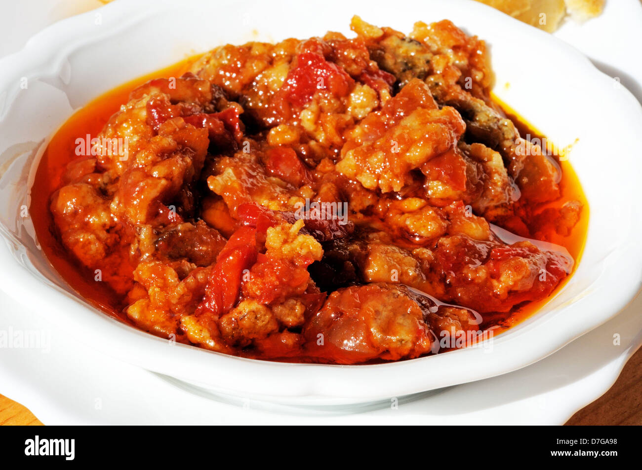 Tapas dish of pieces of cod in red pepper and tomato sauce, Andalusia ...