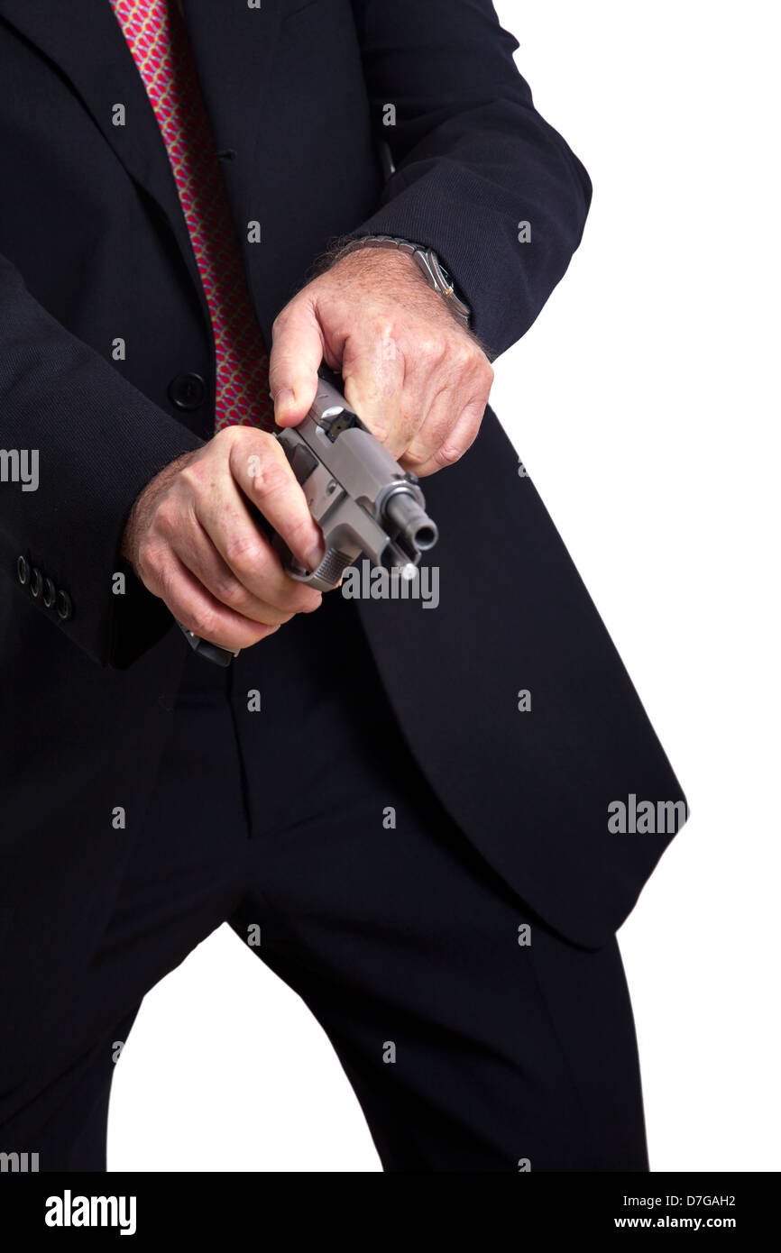A mature adult man wearing a suit, cocking a 9mm gun and getting ready ...