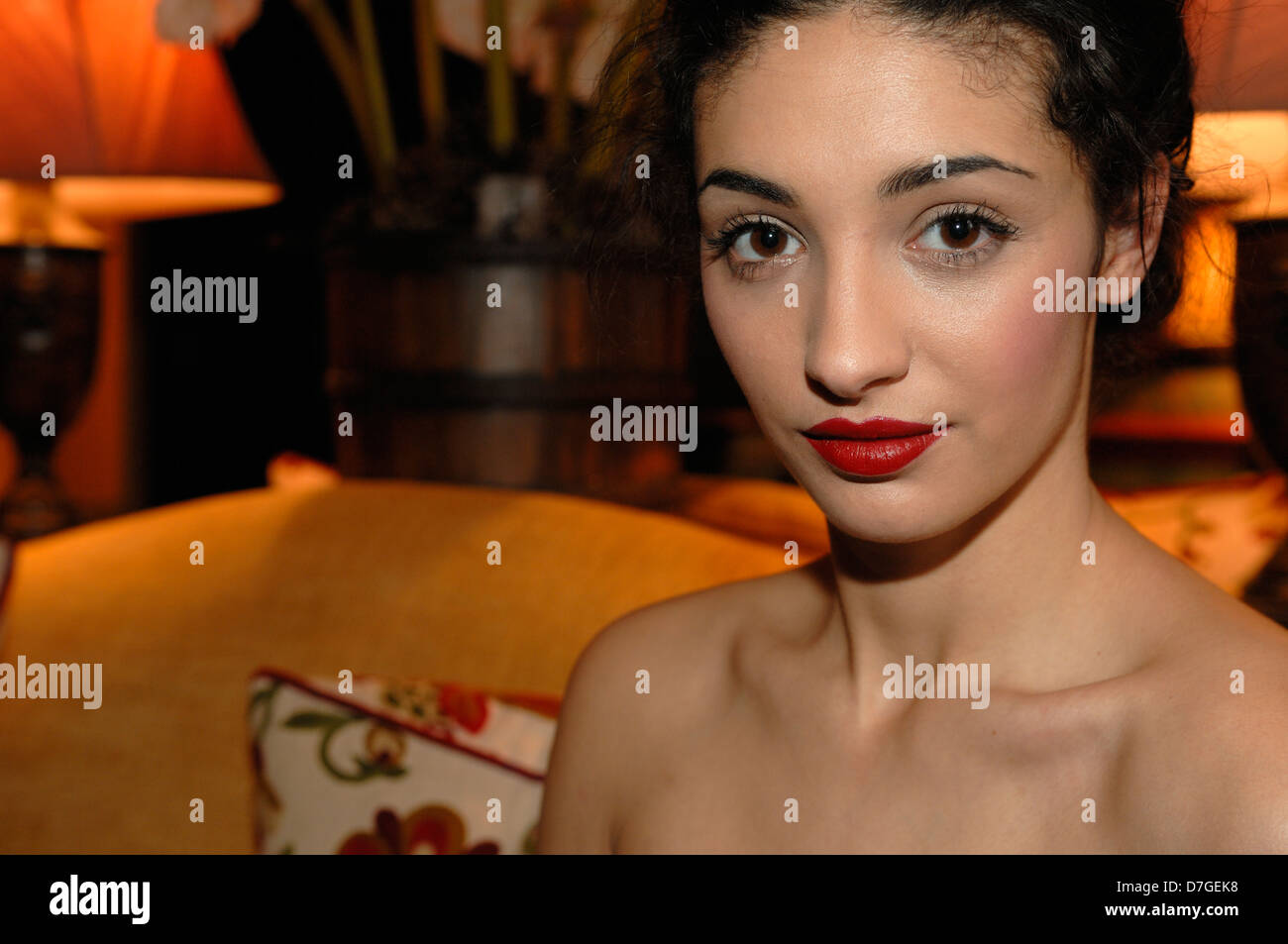 A young lady with refinement sat on a sofa in the hotel drawing room ...