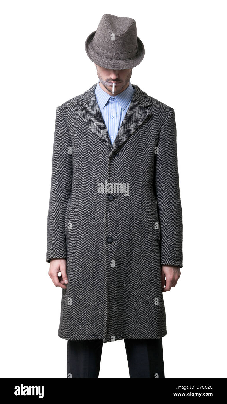 A person dressed in gray overcoat gray hat that is completely hiding ...