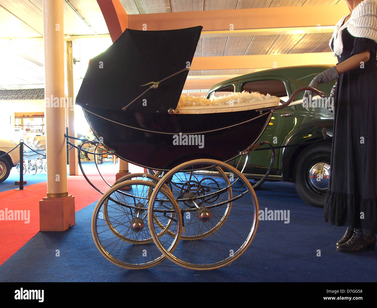 The image depicts an old-fashioned stroller or pram, a vintage design ...