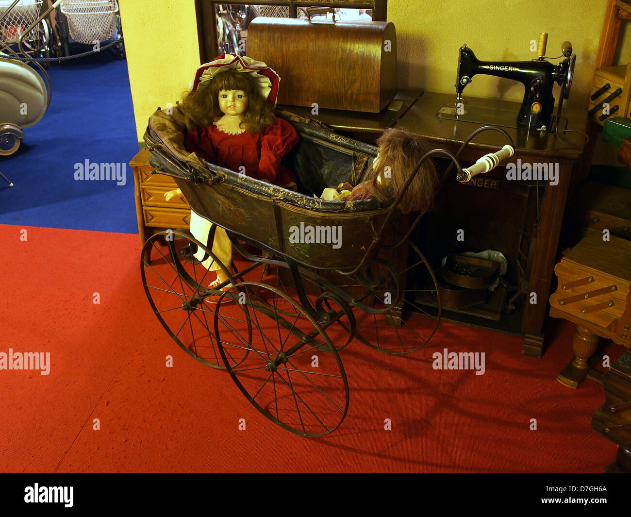 A vintage stroller or pram, common in the early 20th century, showcases ...