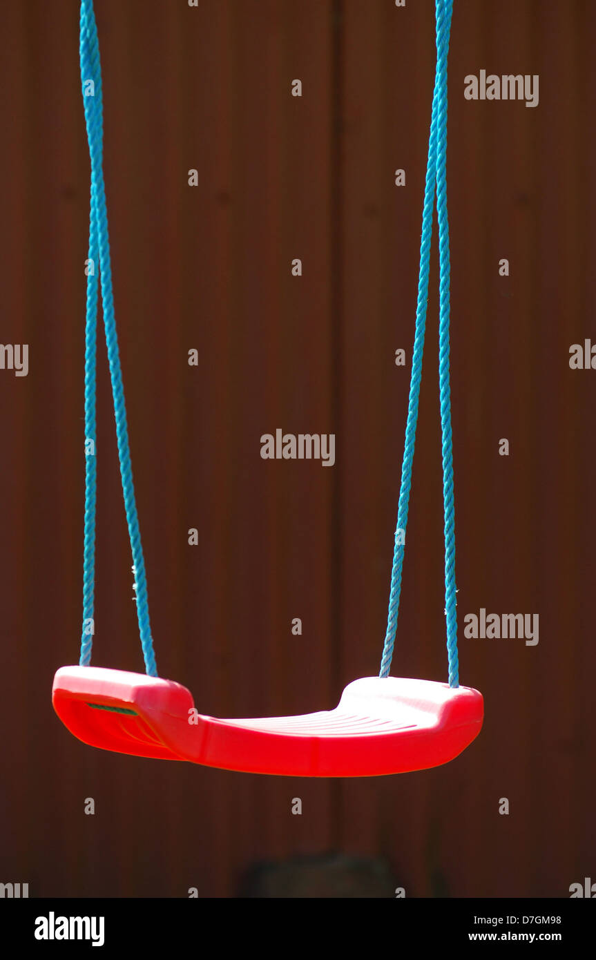 Red swing hi-res stock photography and images - Alamy