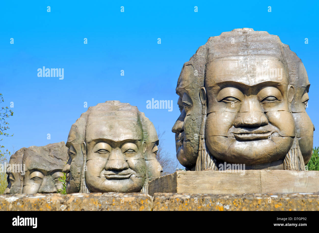Carved stone idol head statues Stock Photo - Alamy